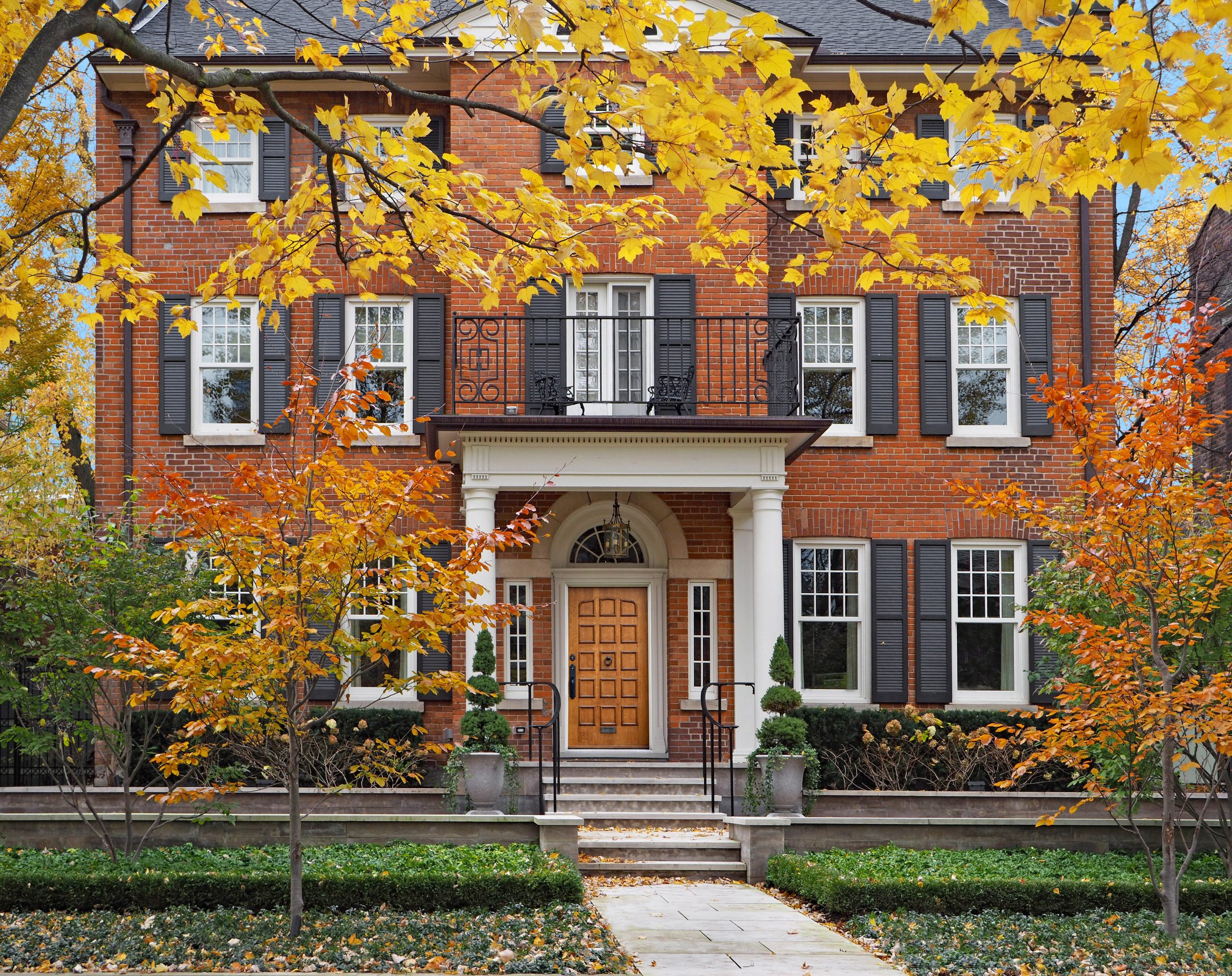 large brick house surrounded by trees with fall colors - County Lines ...